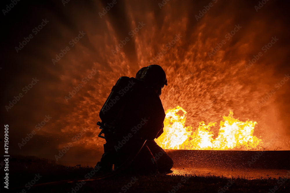 Firefighter training, fireman using water and extinguisher to fighting ...
