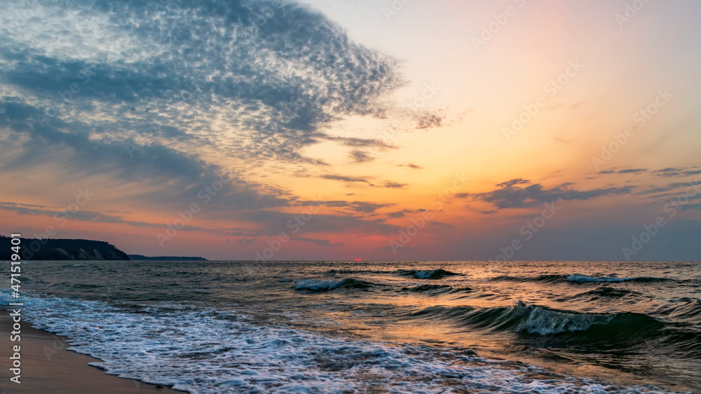 The last red ray of sunset in the wavy sea, a rare optical phenomenon ...