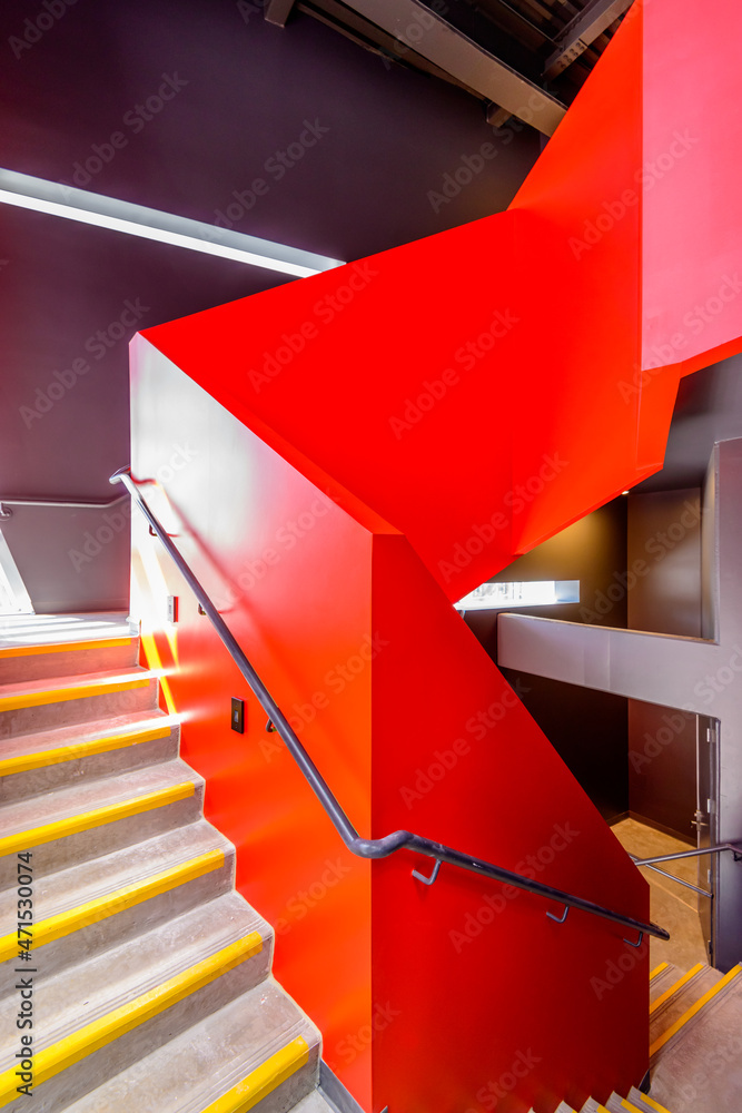Staircase painted in red. Abstract fragment of the architecture of ...
