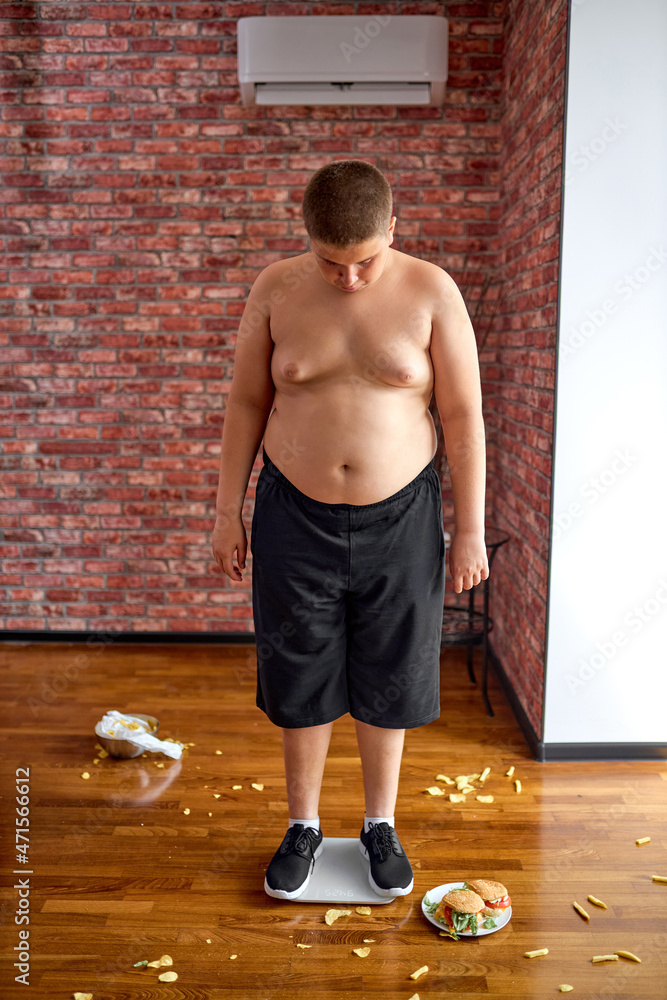 Upset overweight boy after weighing. Teenage kid need to lose some ...