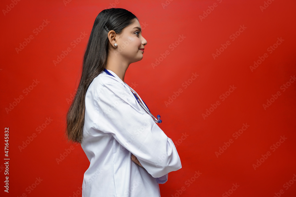young female doctor side pose wearing coat and stethoscope around neck ...