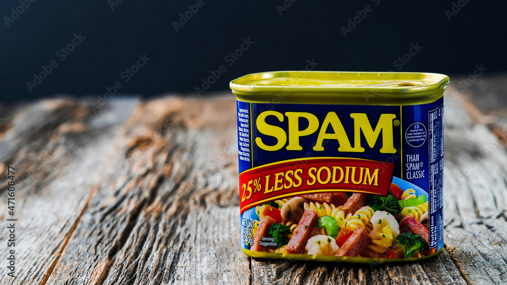 Spam ham can with less sodium on rustic boards with black background ...