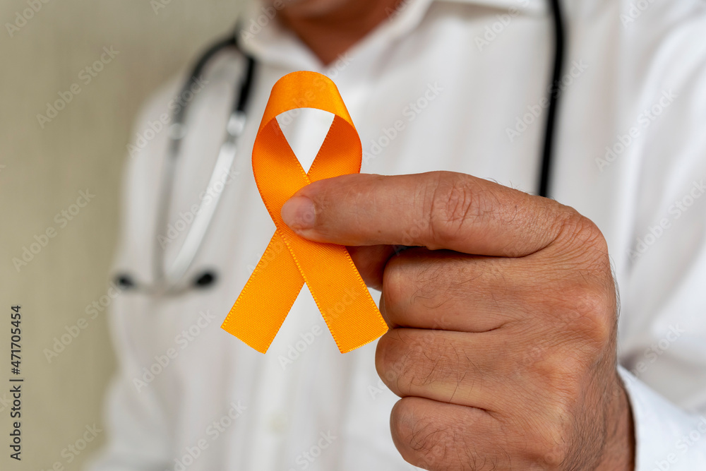 doctor holding orange ribbon. campaign to prevent skin cancer, melanoma ...