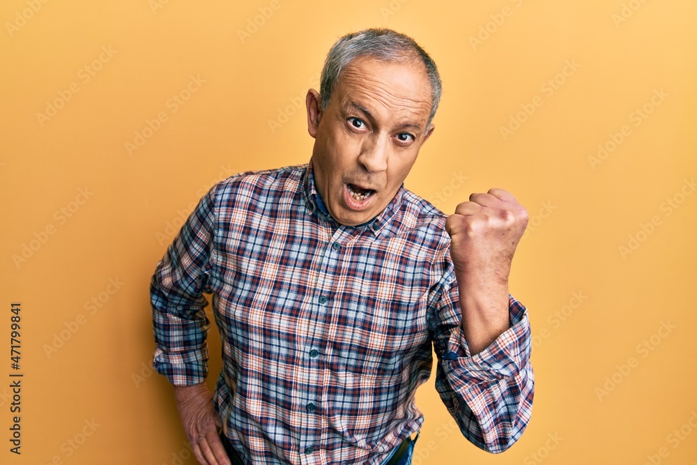 Handsome senior man with grey hair wearing casual shirt angry and mad ...