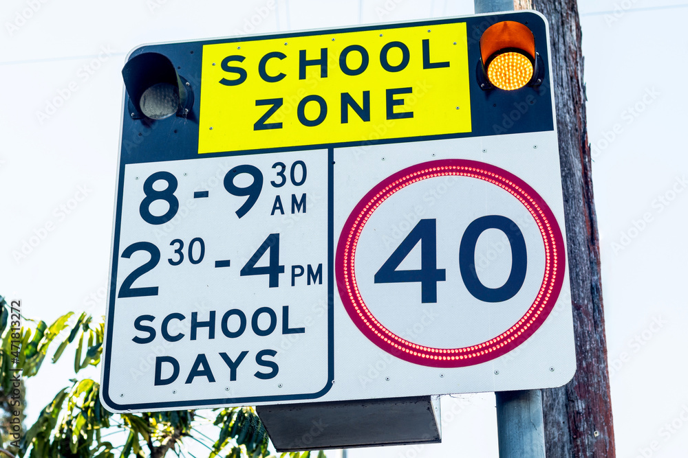 School zone road sign with speed limit 40 during before and after ...