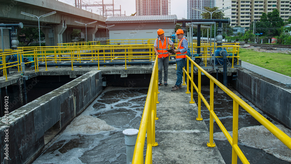 service engineer checking on waste water treatment plant with pump on ...