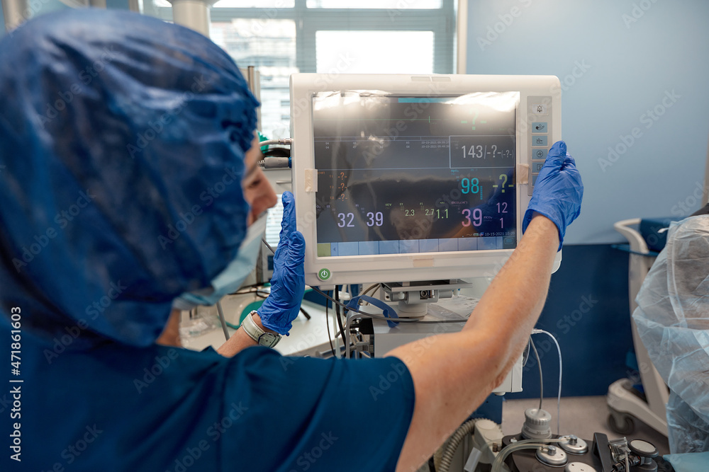 surgeon keeping track of vital functions of the body during cardiac ...