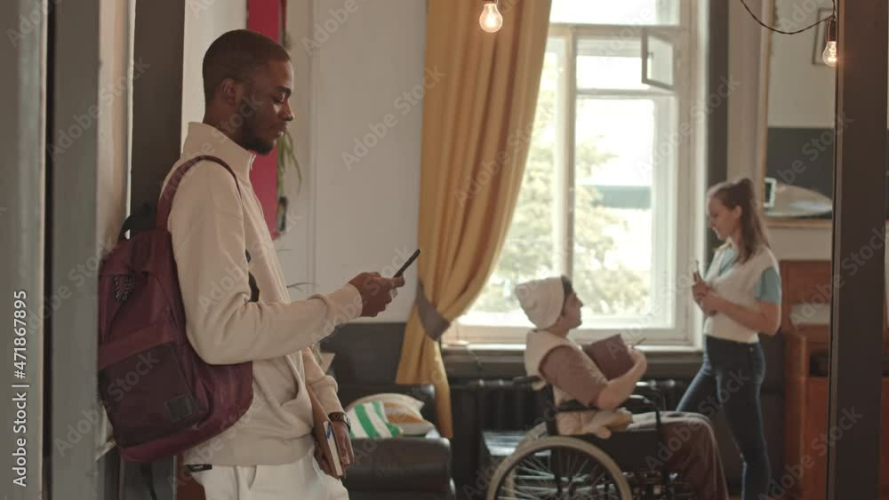 Medium slowmo shot of male African-American university student ...