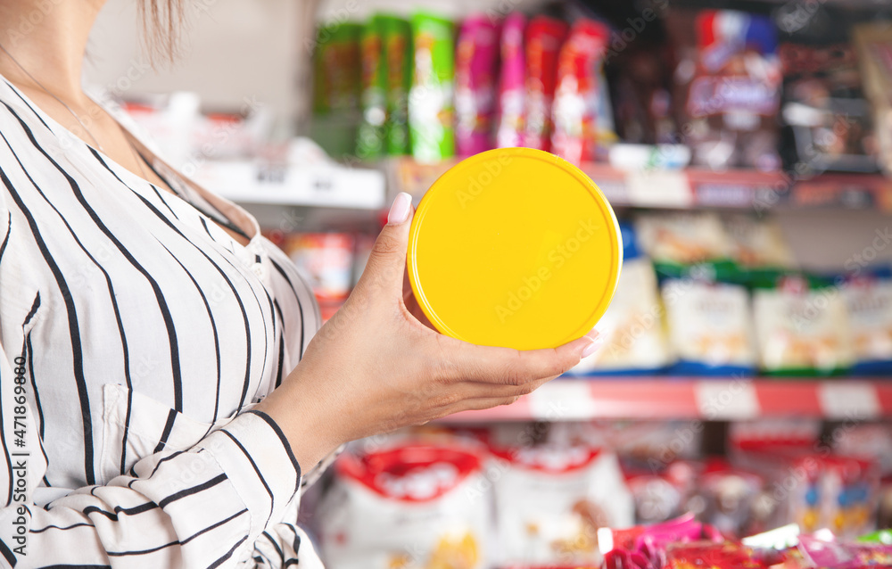 Girl holding sweets box in supermarket. Stock Photo | Adobe Stock