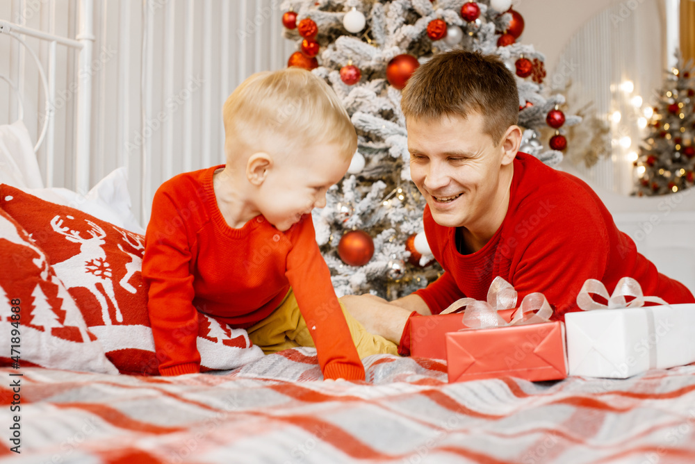 Merry Christmas and happy holidays. Loving dad with cheerful son play ...