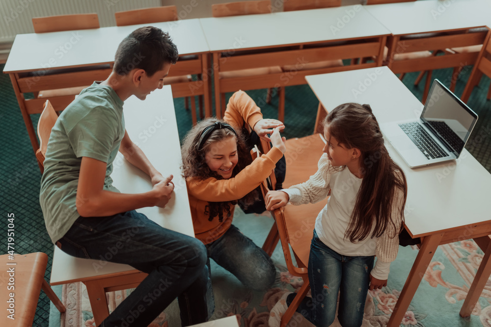Top view photo of group of school kids learning on laptop with their ...