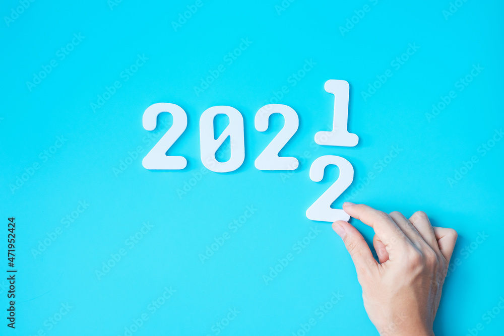 hand change 2021 to 2022 number on blue background. Plan, finance ...