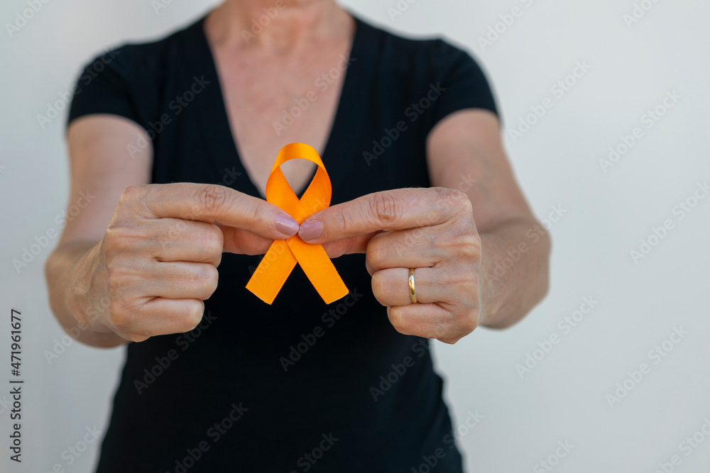 December orange. woman holding orange ribbon. campaign to prevent skin ...