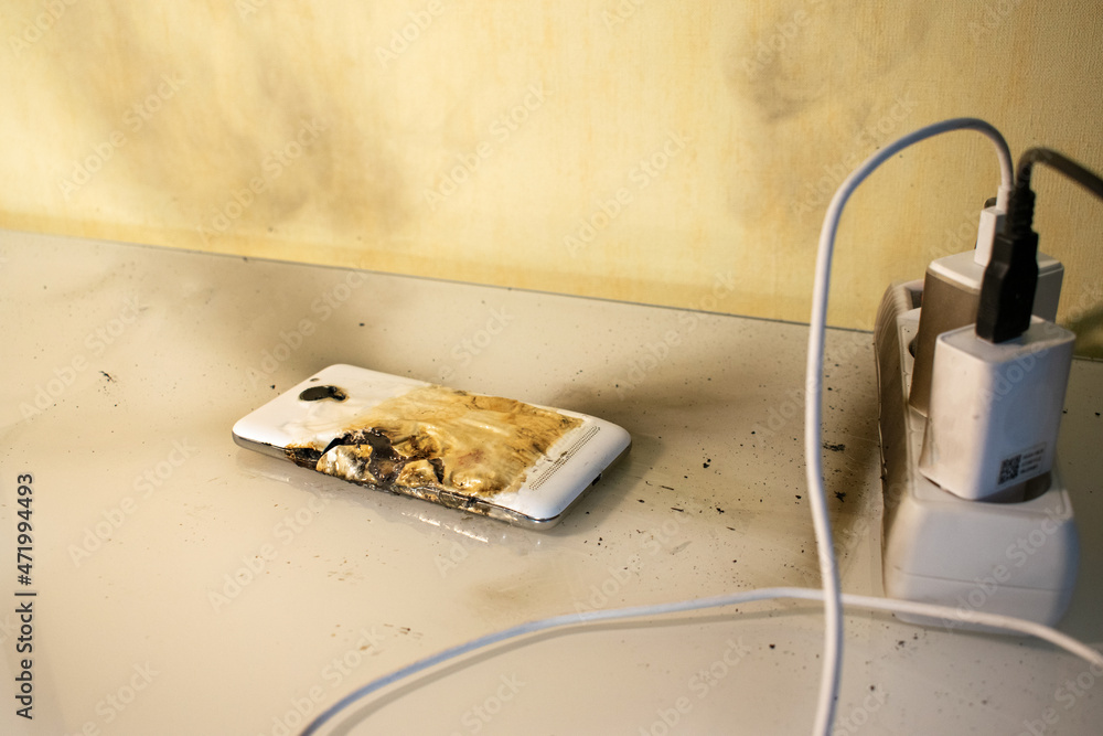 Smartphone battery explosion as a result of a long charge Stock Photo ...