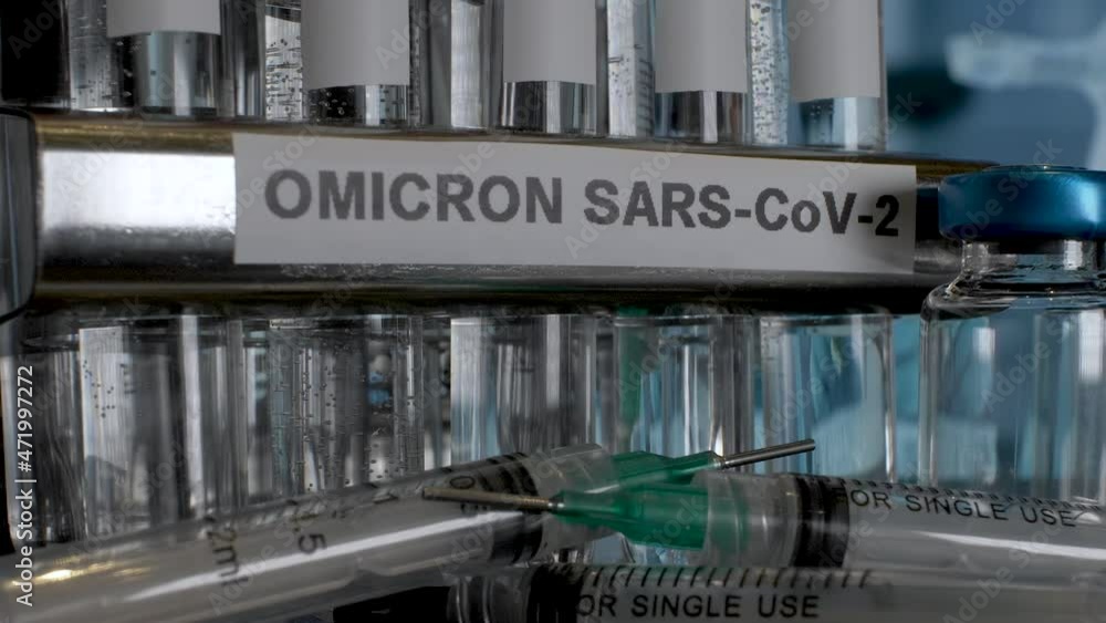 A close up dolly shot of a laboratory rack labelled Omicron SARS-CoV-2 ...