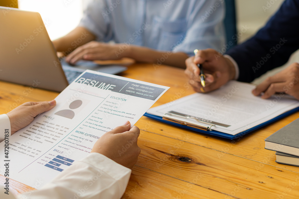 Closeup resume in manager's hand when discussing resume with conference ...