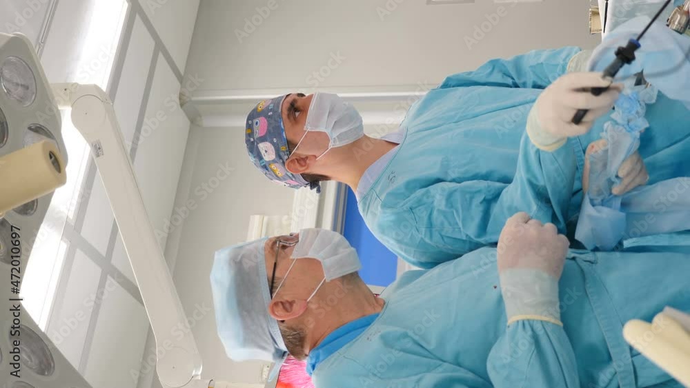 Healthcare concept. Surgeon with assistants makes laparoscopic surgical ...