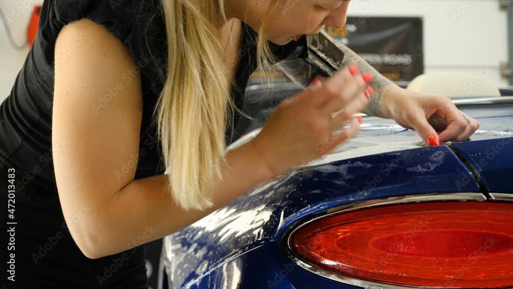 Close up to PPF installation process on a front headlight and hood. PPF ...