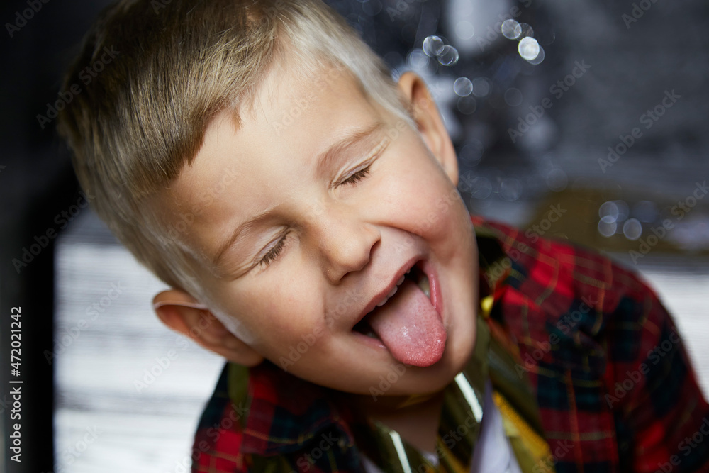 Adorable cheerful child makes a funny face expression close up. Funny ...
