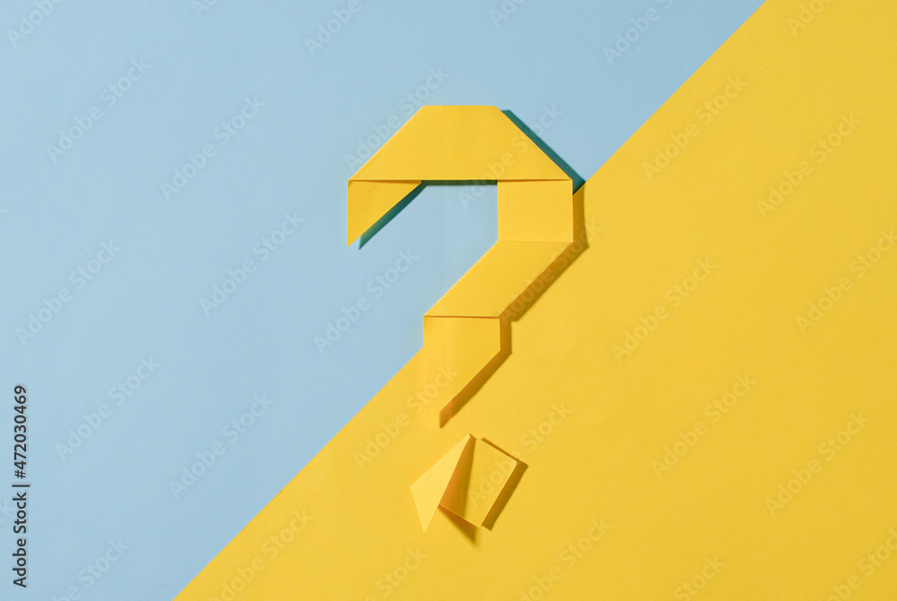 Yellow origami question mark on a diagonal two tone background Stock ...