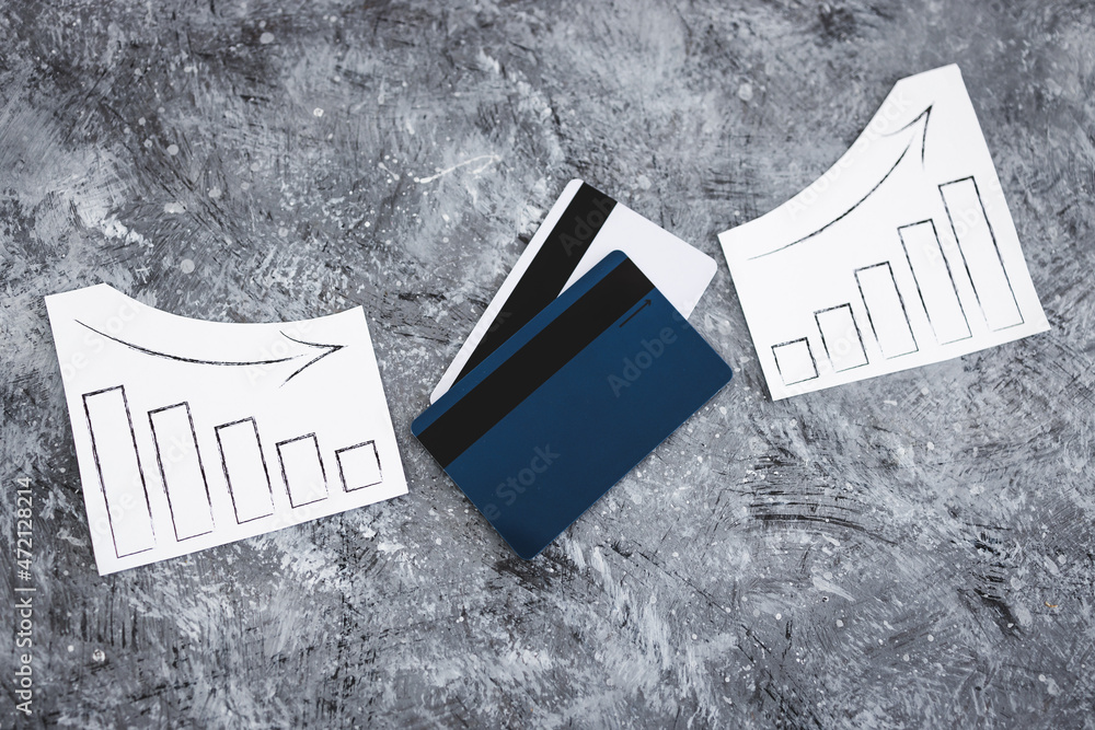 financial markets or money and investments, payment cards with charts ...