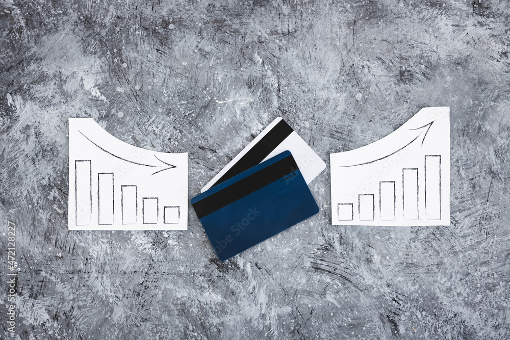 financial markets or money and investments, payment cards with charts ...
