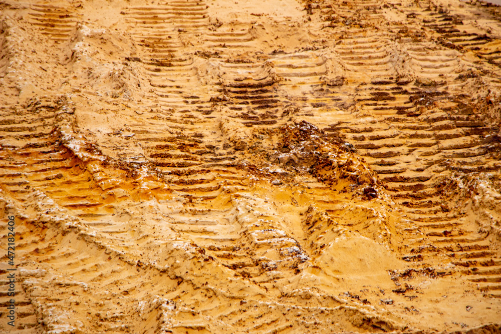 Textural sand, with relief surface, multi-colored layers and different ...