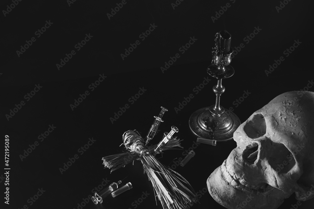 Voodoo doll and candles. Skull and syringes on a black background ...