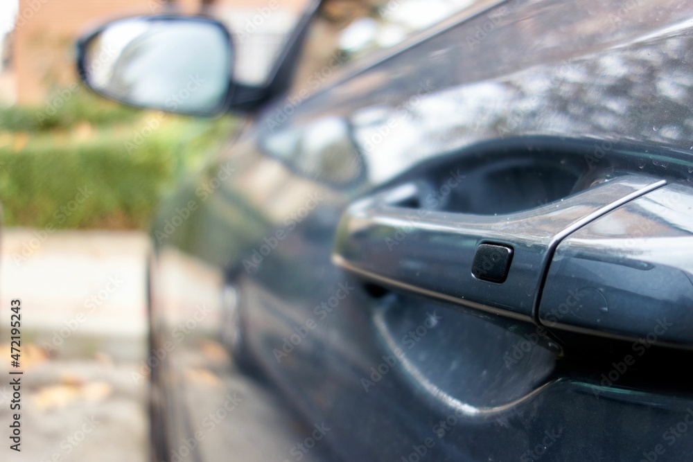Button on the door handle of a modern car that replaces the classic key ...