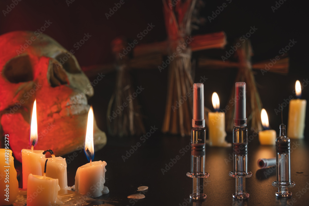Voodoo and candles. Skull and syringes on a black background. People ...