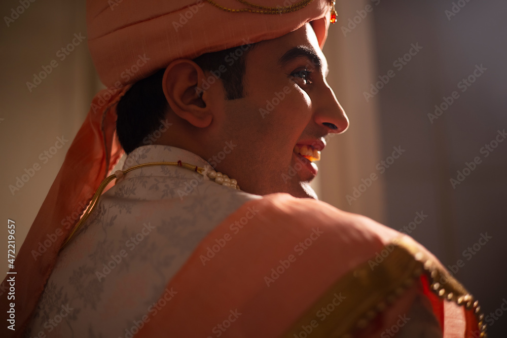 Side view of Indian groom in traditional wedding outfit Stock Photo ...
