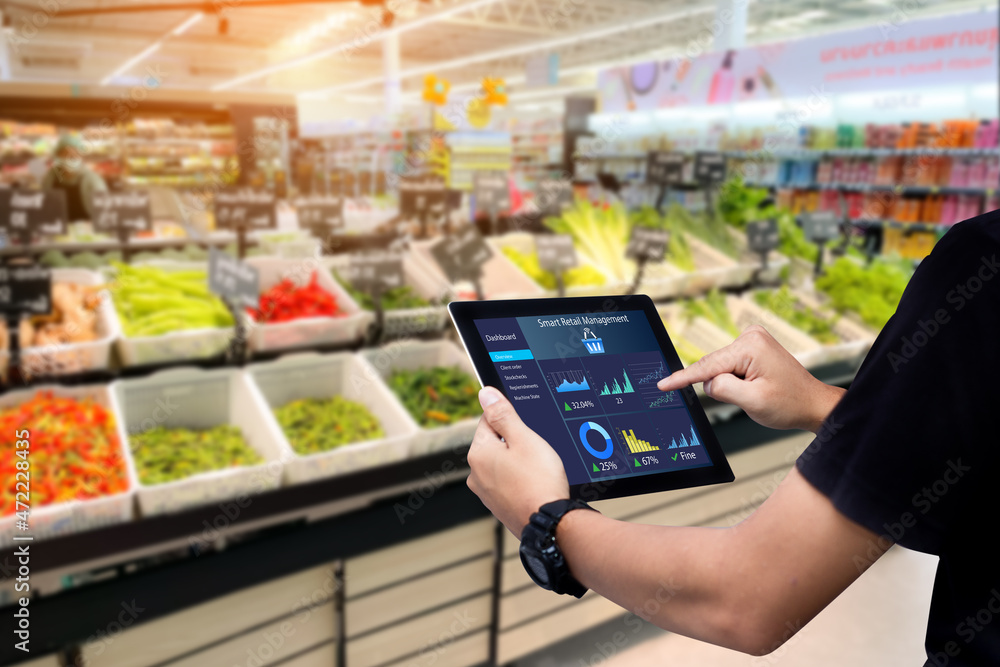 Smart retail management system.Worker hands holding tablet on blurred ...