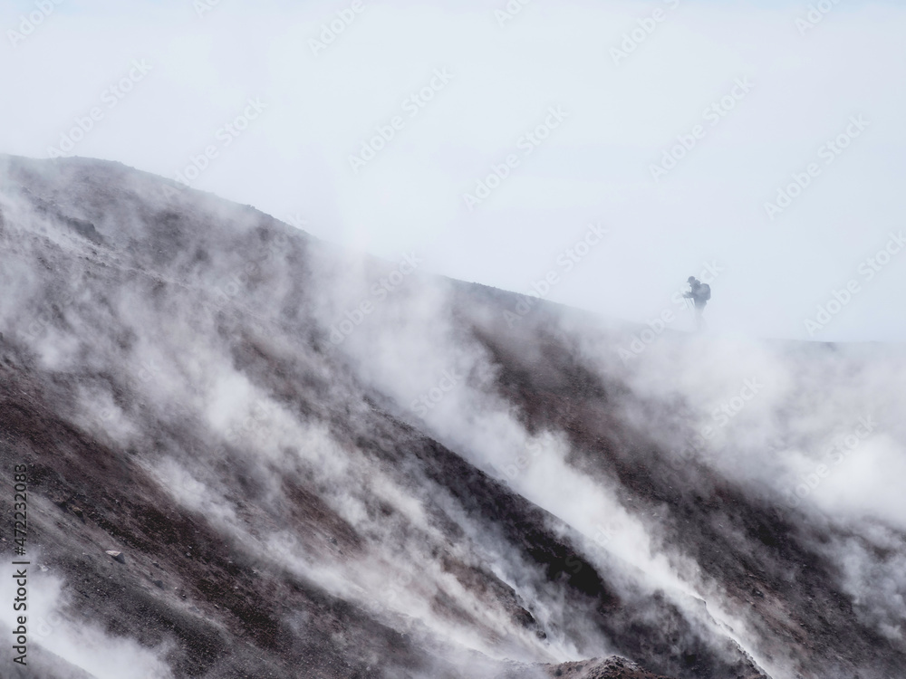 Silhouette of man hiking at coldera of Avachinsky stratovolcano, also ...