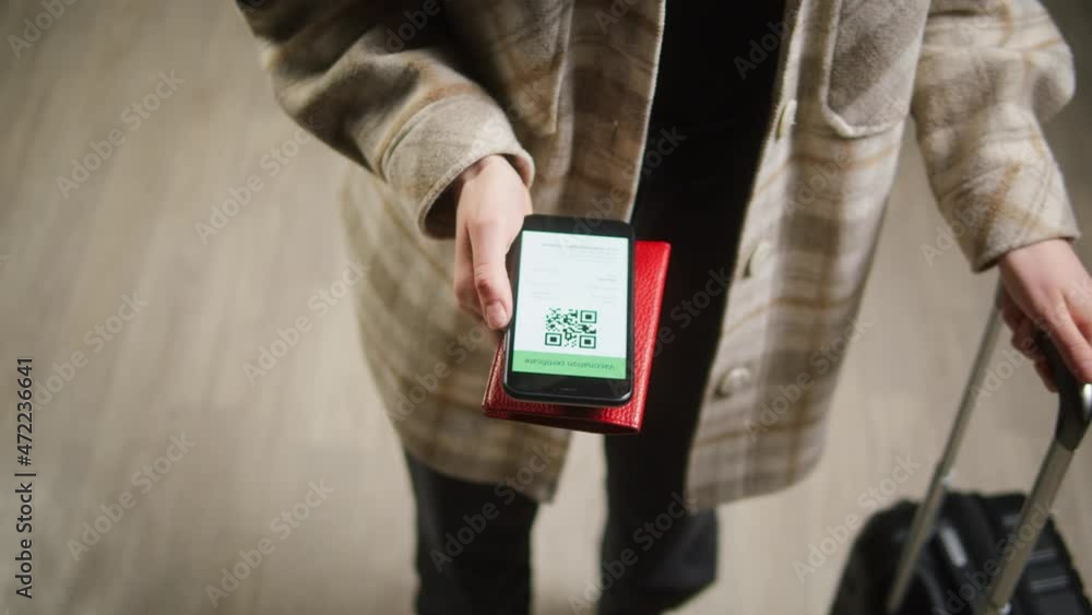 Tourist showing QR code on phone in airport terminal. Vaccination ...
