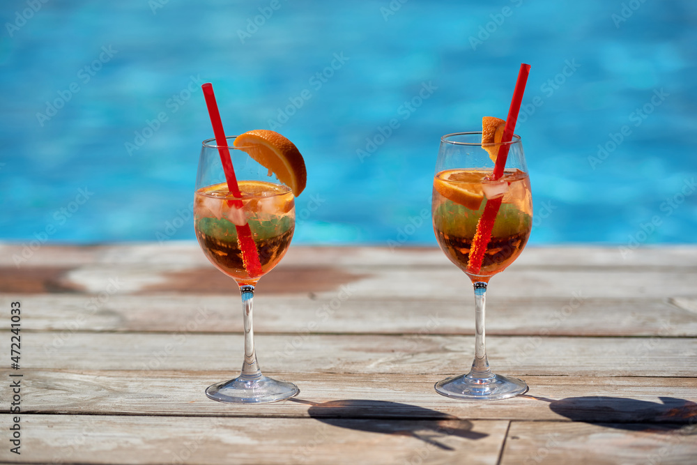 Aperol spritz cocktails on summer party by the pool, copy space. Event ...