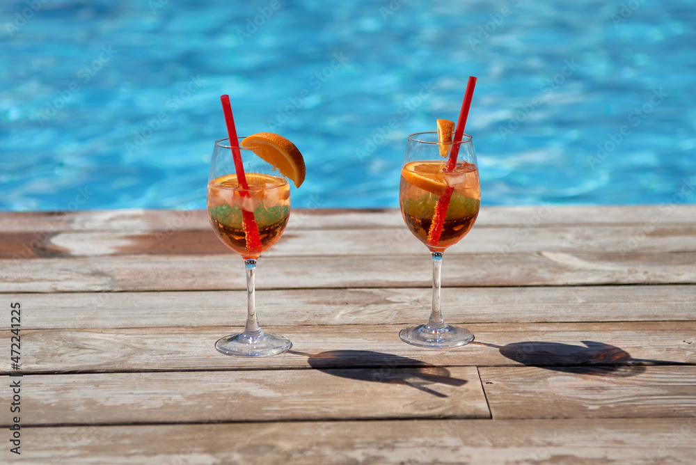 Aperol spritz cocktails on summer party by the pool, copy space. Event ...