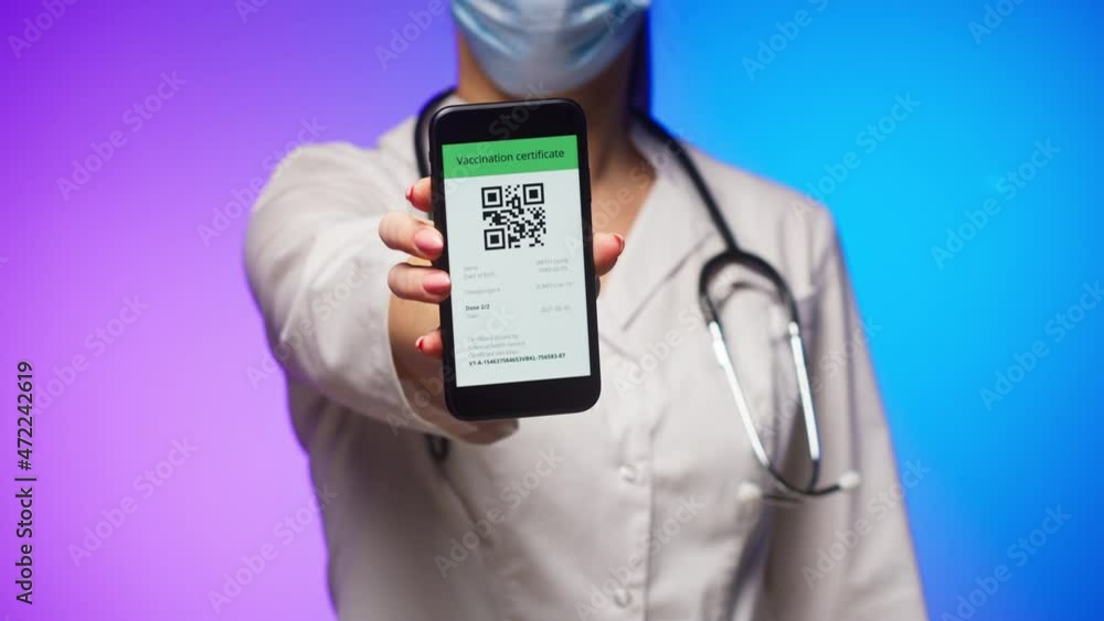 Woman doctor in medical uniform showing vaccination passport with qr ...