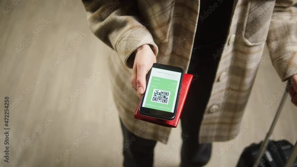 Tourist showing QR code on phone in airport terminal. Vaccination ...