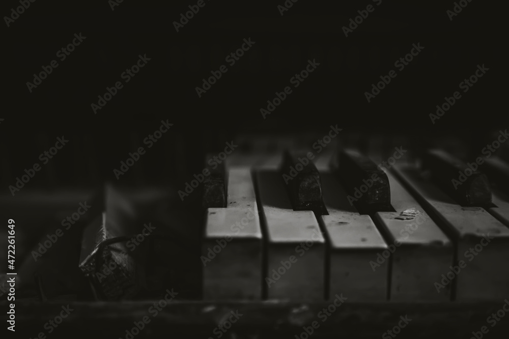 Black and white dirty keys of an abandoned piano. An old musical ...