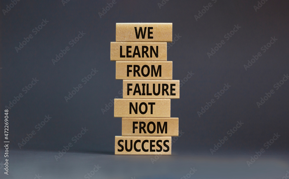Failure or success symbol. Wooden blocks with words We learn from ...
