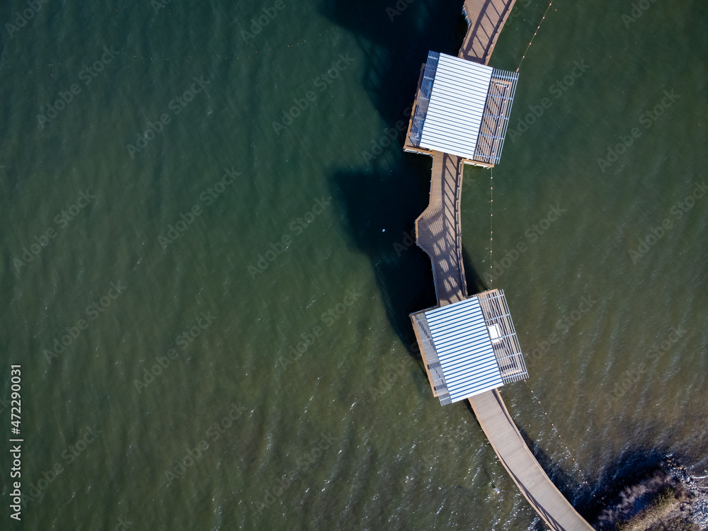 Curved boardwalk on Lake Wylie in South Carolina with deep green water ...