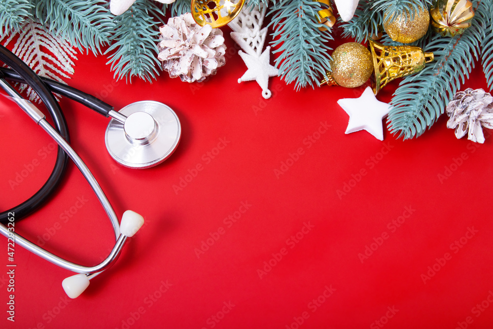 Medical stethoscope and christmas decorations on red background with ...