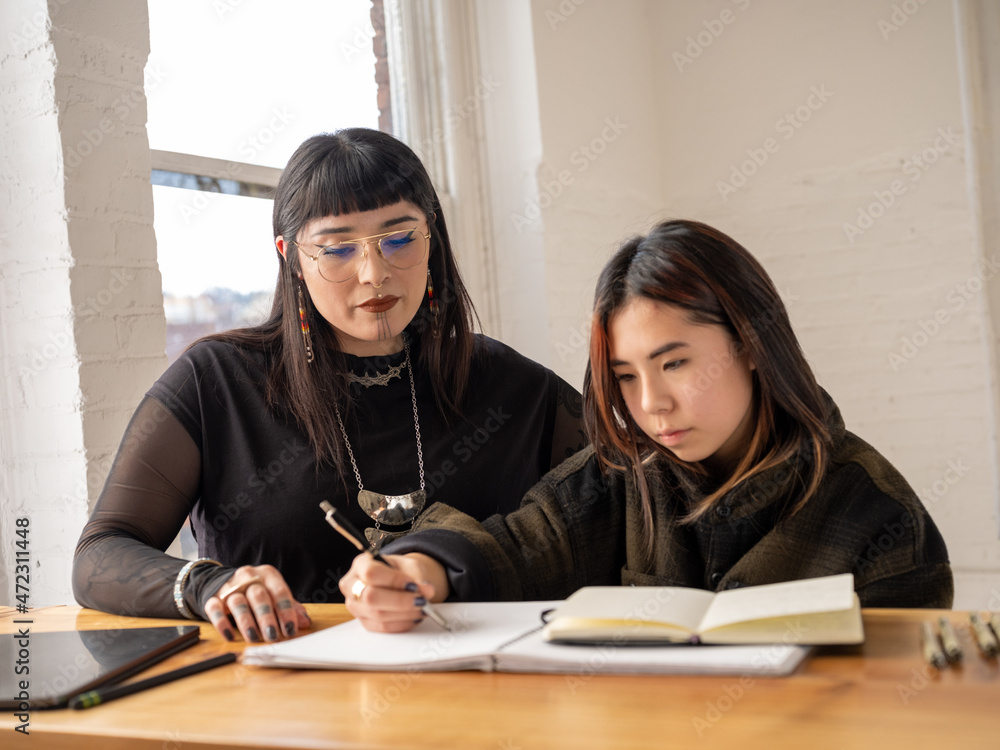 Non binary artist and non-binary student drawing indoors Stock Photo ...