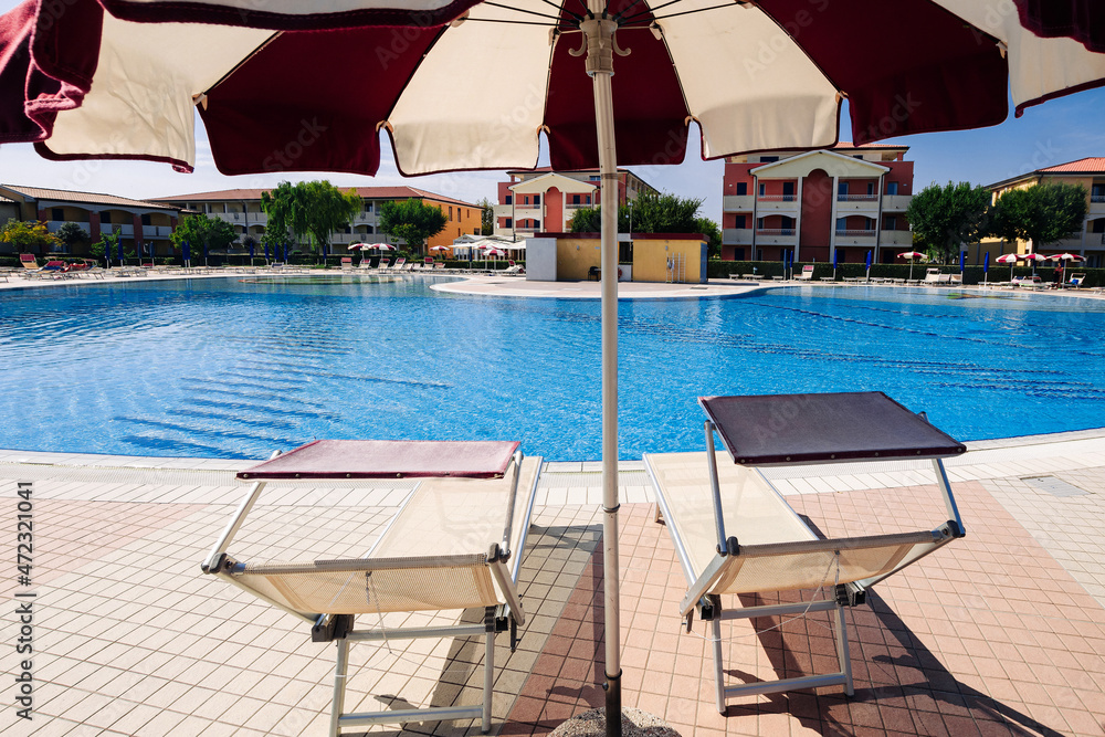 Resort pool. Summer resort chair, relax lounge at luxury hotel pool ...