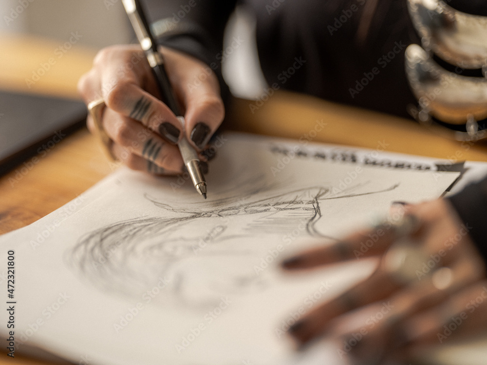 Non binary Indigenous artist drawing indoors Stock Photo | Adobe Stock