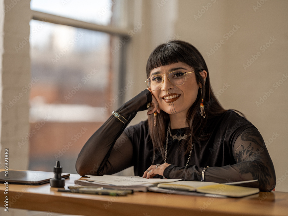 Non binary Indigenous artist drawing indoors Stock Photo | Adobe Stock