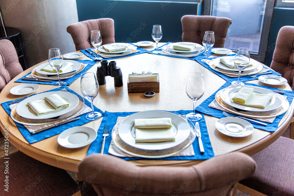 Round dining table for seven. Interior of cozy luxury restaurant with ...
