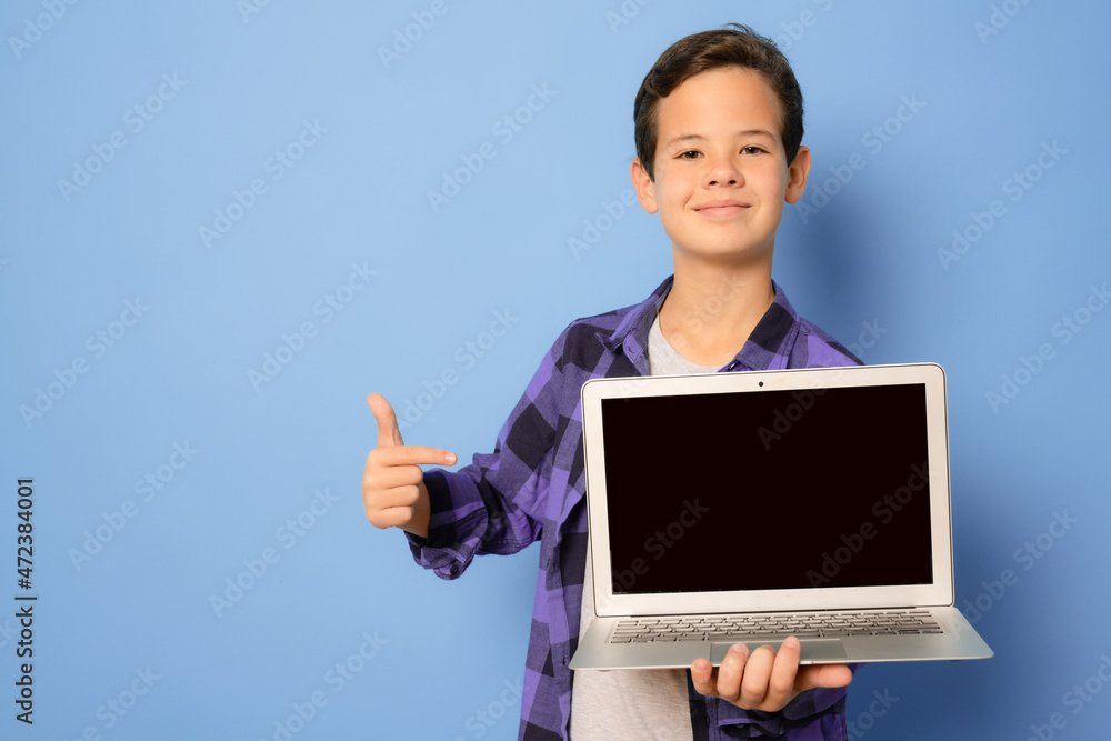 Cute kid boy in plaid shirt pointing finger to laptop screen isolated ...