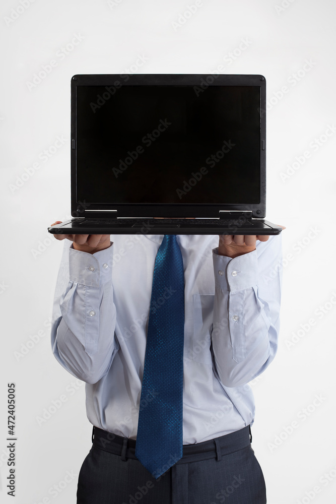business man holding his laptop with white blank screen at face height ...
