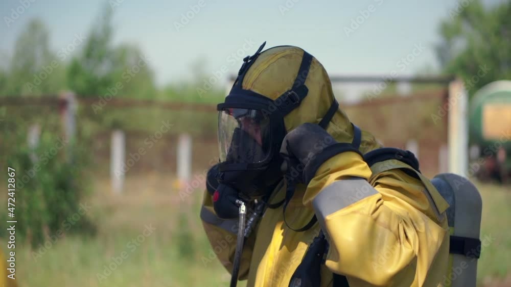 Work in a gas mask. Clip. Working moment in the danger zone in a ...